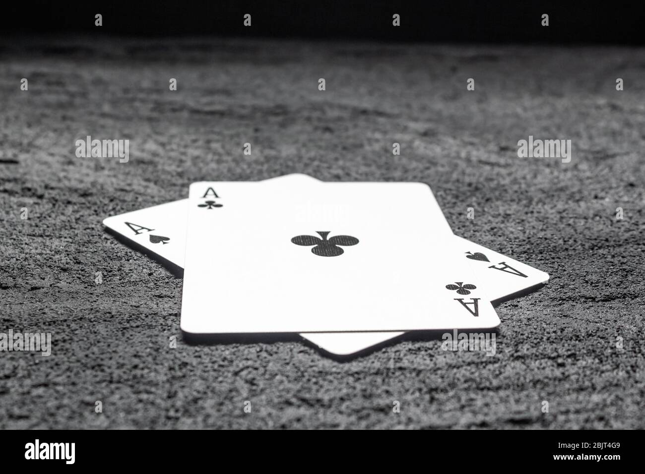 two black aces spades and crosses on black concrete dark background ...