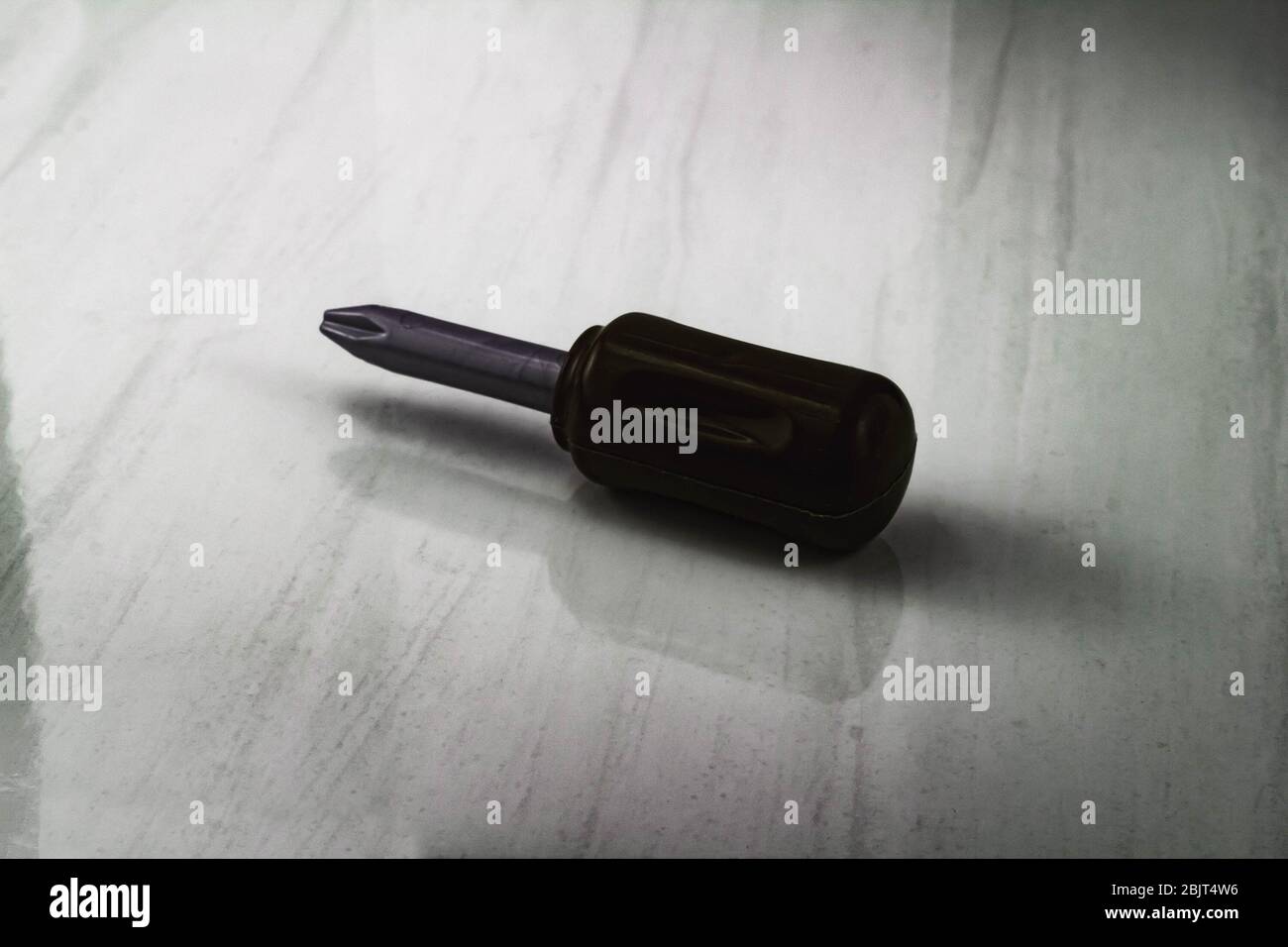 Children's toy screwdriver on white marble one Stock Photo - Alamy