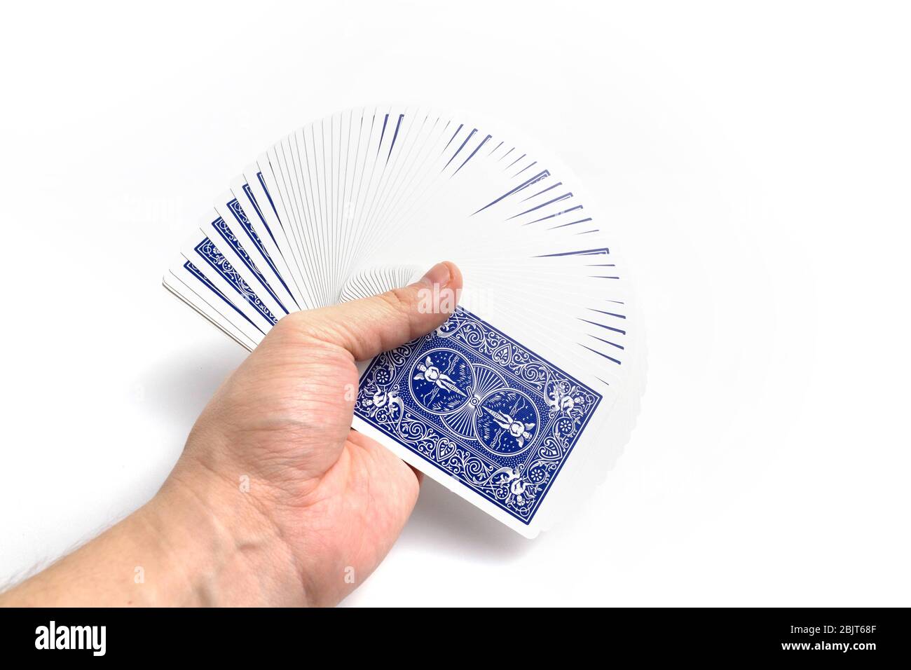 Card fan in hand on a white background isolate Stock Photo - Alamy