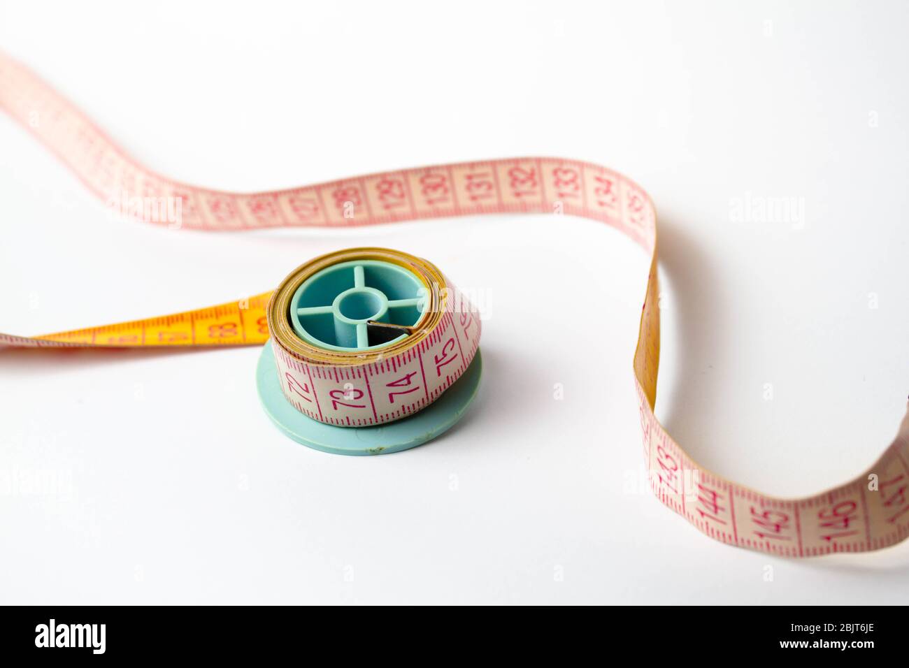 Meter for fabric on a white background isolate Stock Photo - Alamy