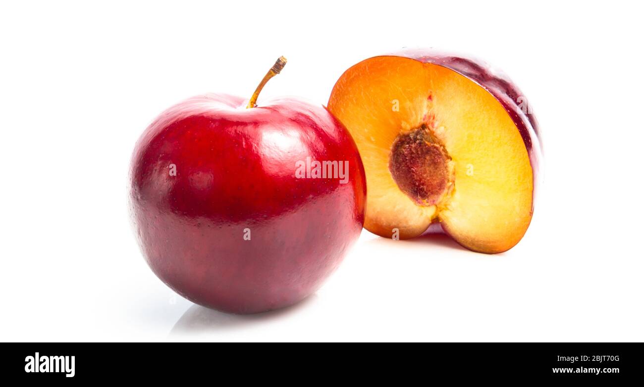 Ripe red plum in a cut on a white background. close up Stock Photo - Alamy
