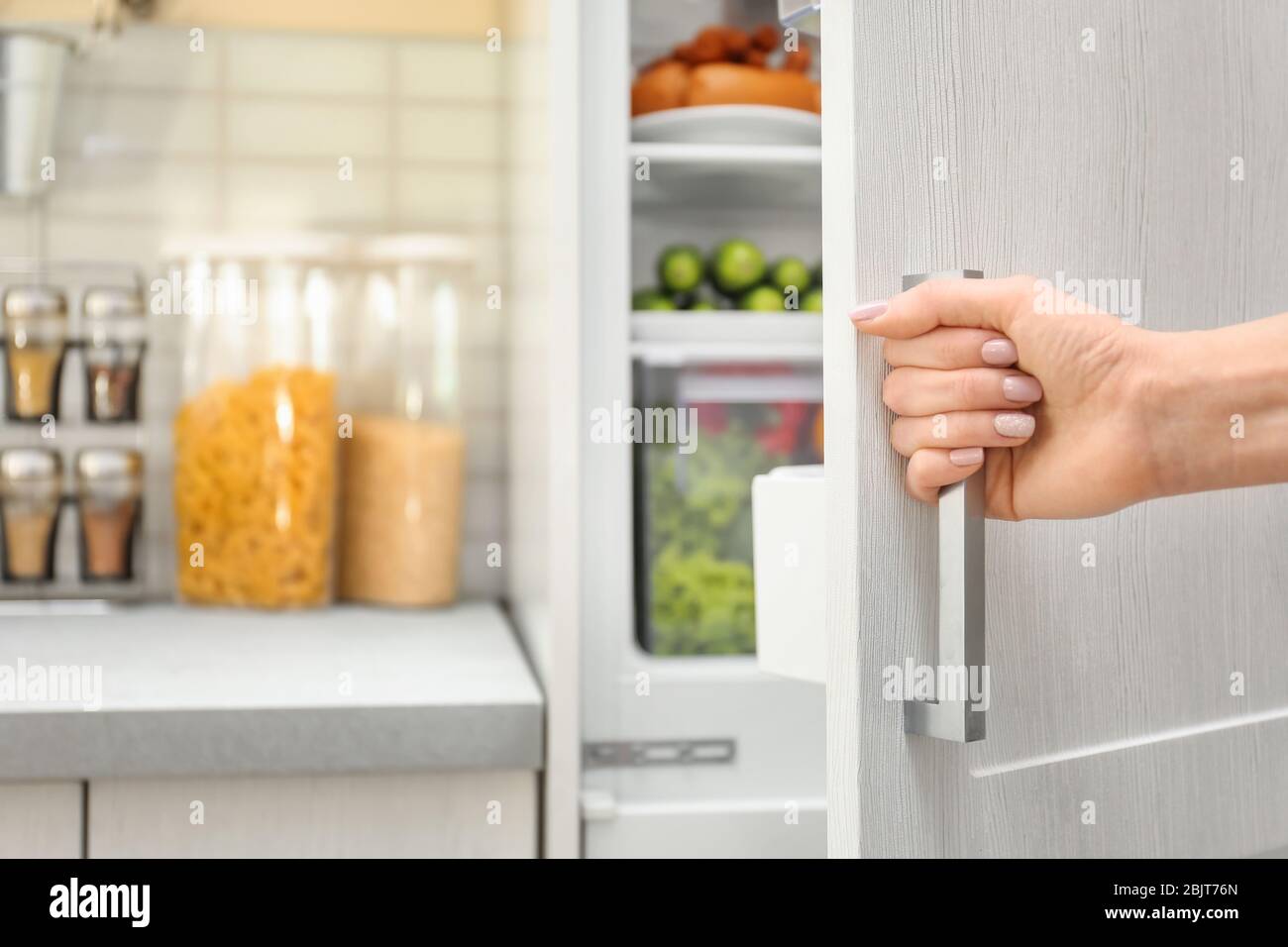 Woman opening refrigerator door hi-res stock photography and images - Alamy