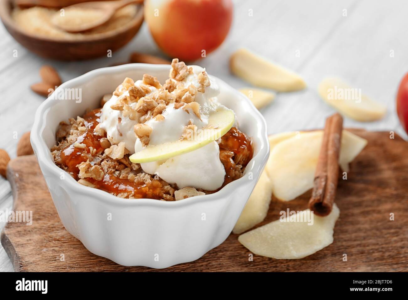 Ramekin with apple crisp on wooden board, closeup Stock Photo - Alamy