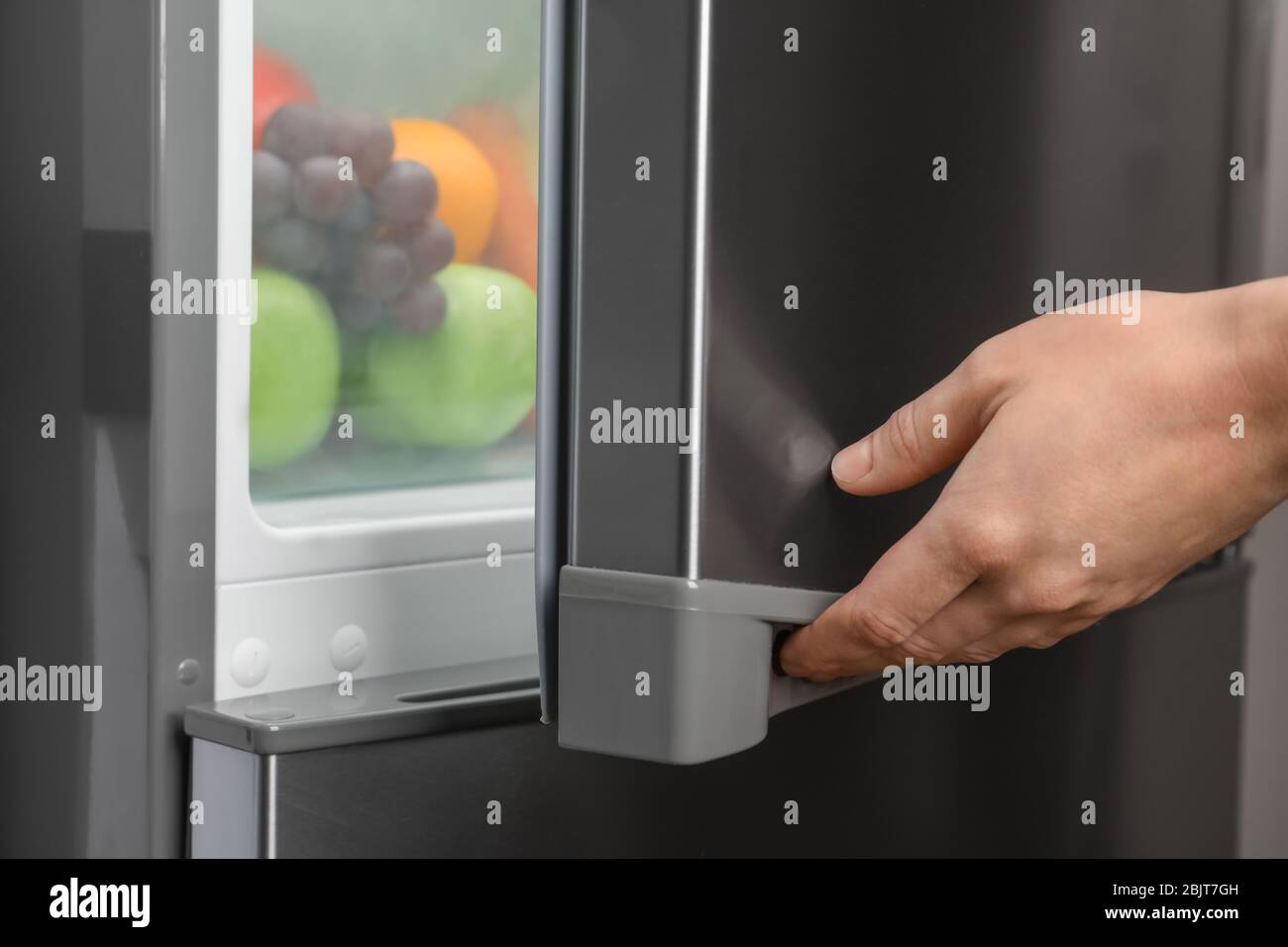 Young woman opening refrigerator, closeup Stock Photo - Alamy