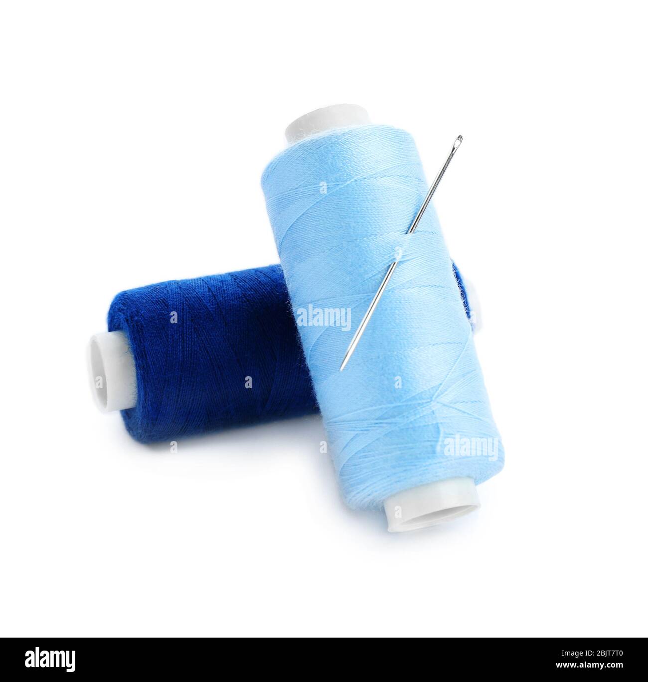 Colorful threads and needle on white background Stock Photo - Alamy