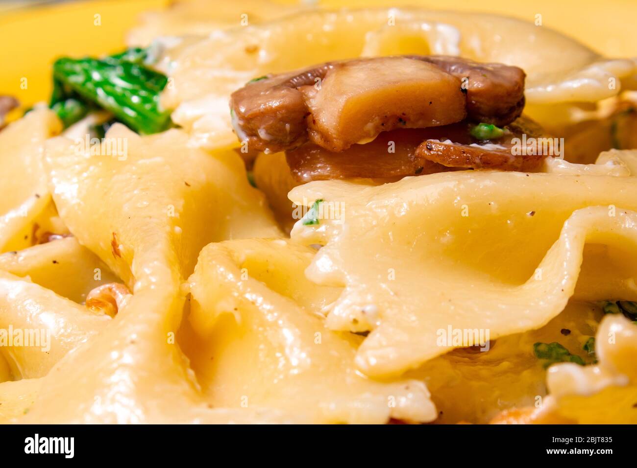 butterfly pasta with fried mushrooms, green spinach Stock Photo - Alamy