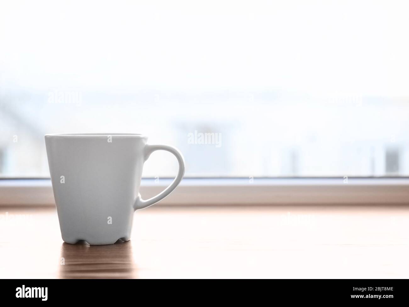Ceramic cup on window sill Stock Photo - Alamy