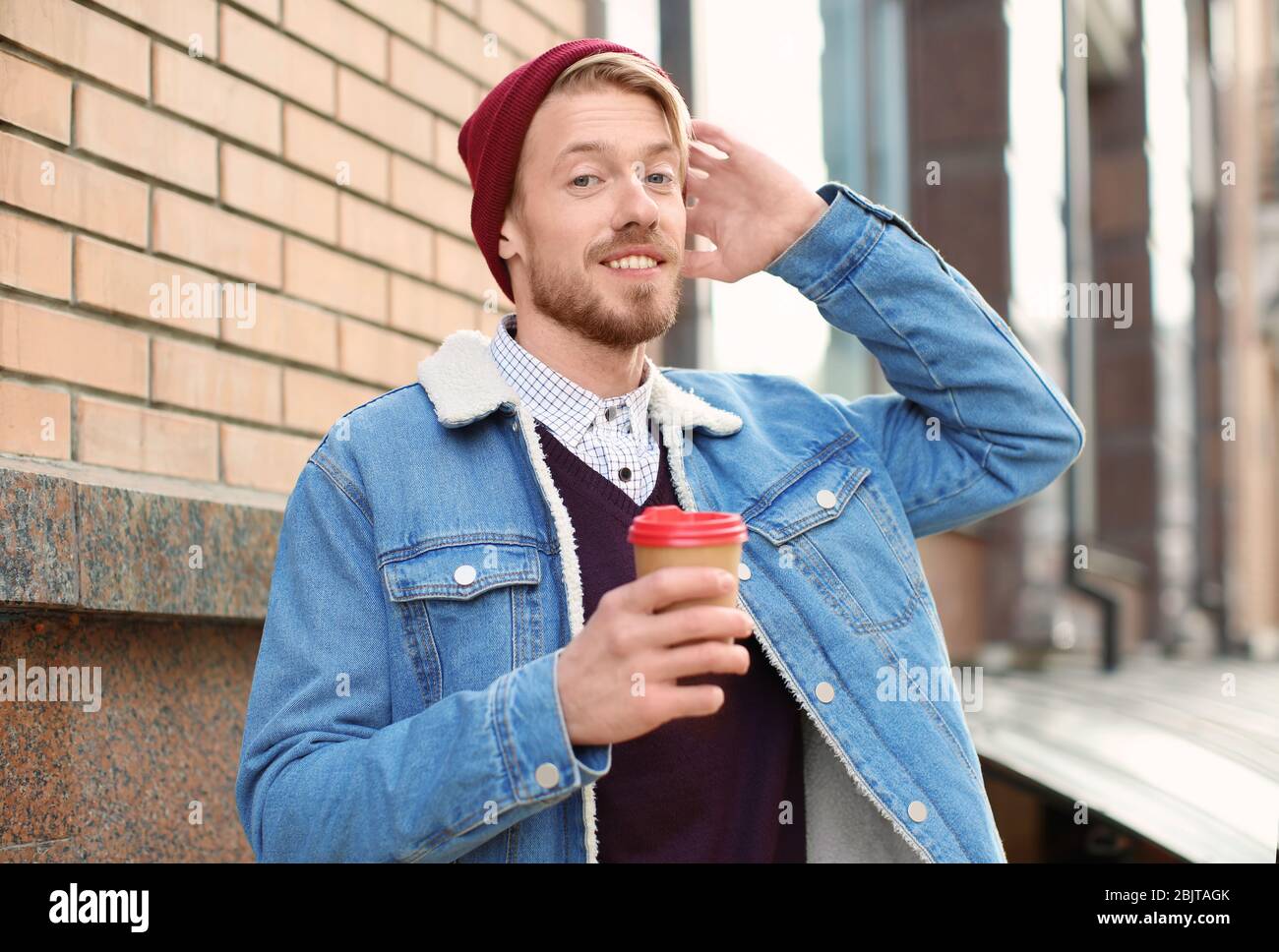 Portrait of trendy hipster drinking coffee outdoors Stock Photo - Alamy