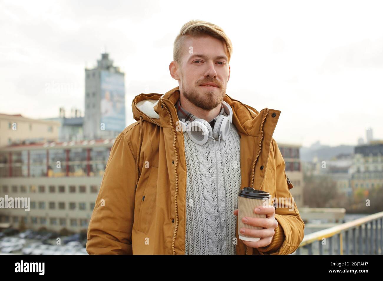 Portrait of trendy hipster drinking coffee outdoors Stock Photo - Alamy
