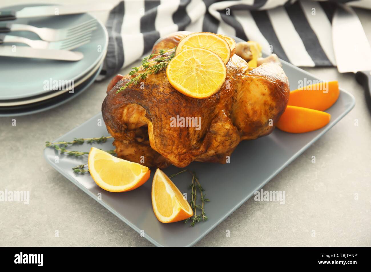 Delicious whole roasted chicken served on plate Stock Photo - Alamy