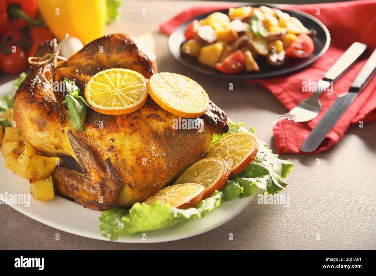 Delicious whole roasted chicken served on plate Stock Photo - Alamy
