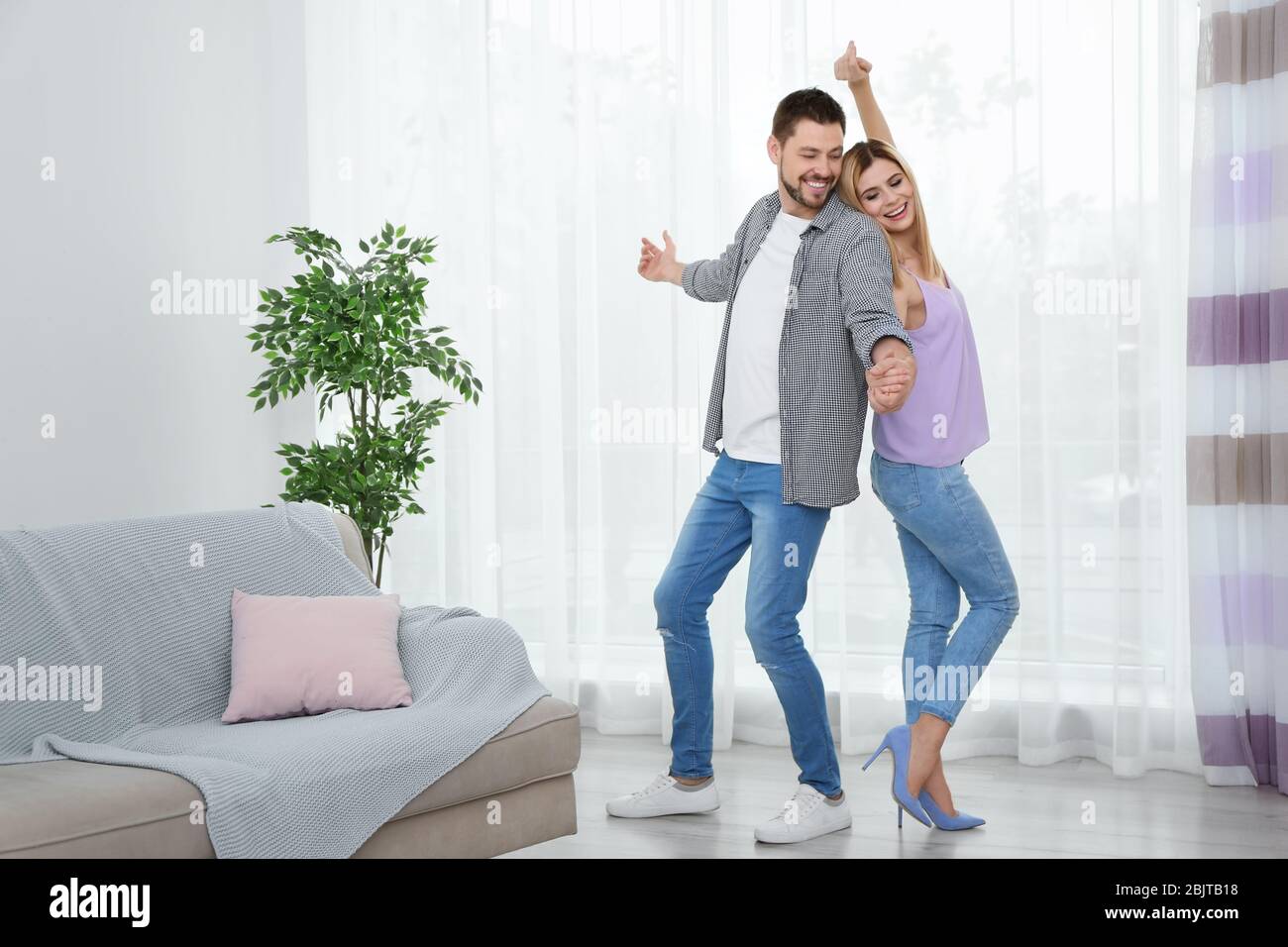 Happy couple dancing at home Stock Photo - Alamy
