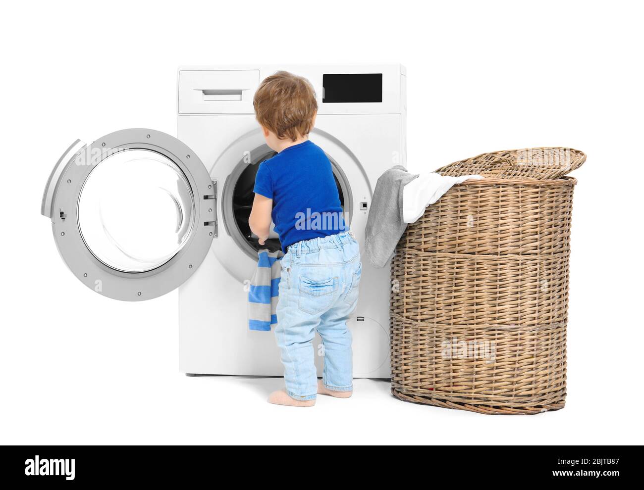 Cute little boy doing laundry on white background Stock Photo - Alamy