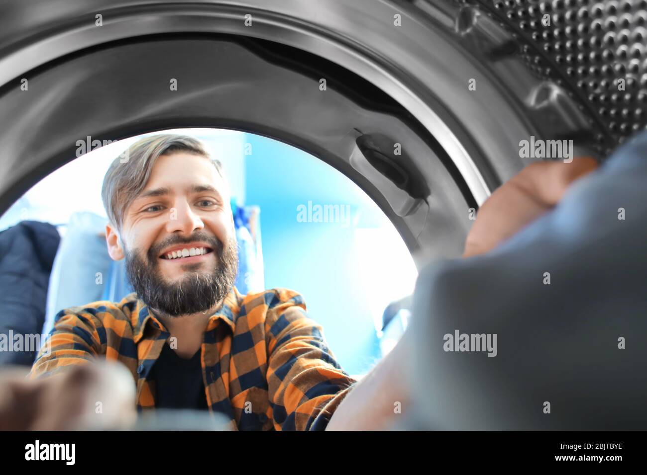 Man washing clothes launderette hi-res stock photography and images - Alamy