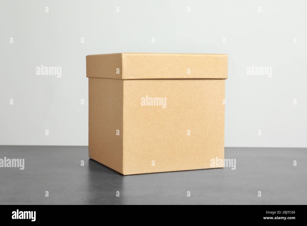 Cardboard box on table against white background. Mockup for design ...