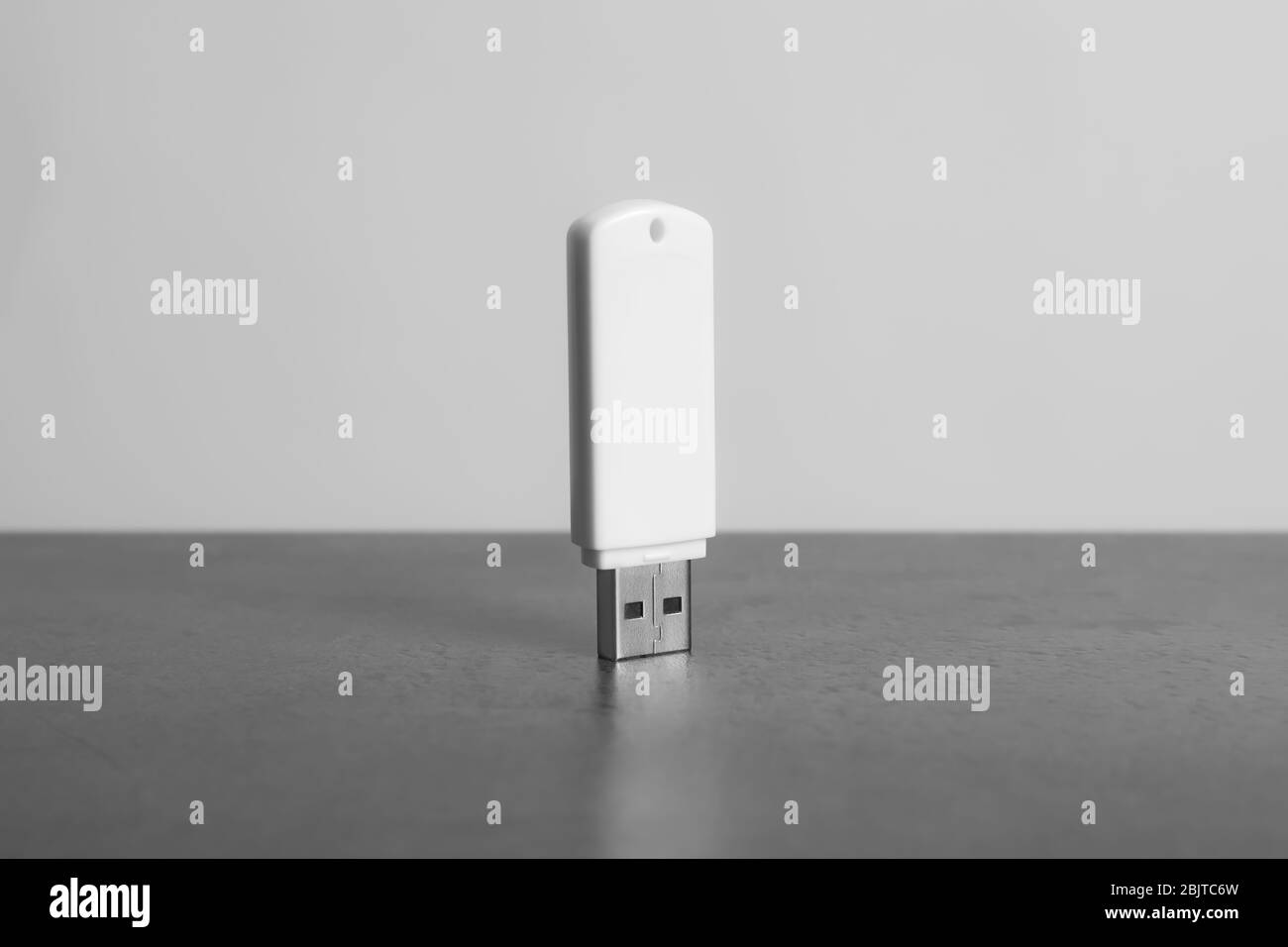 Blank USB flash drive on table against white background. Mockup for ...