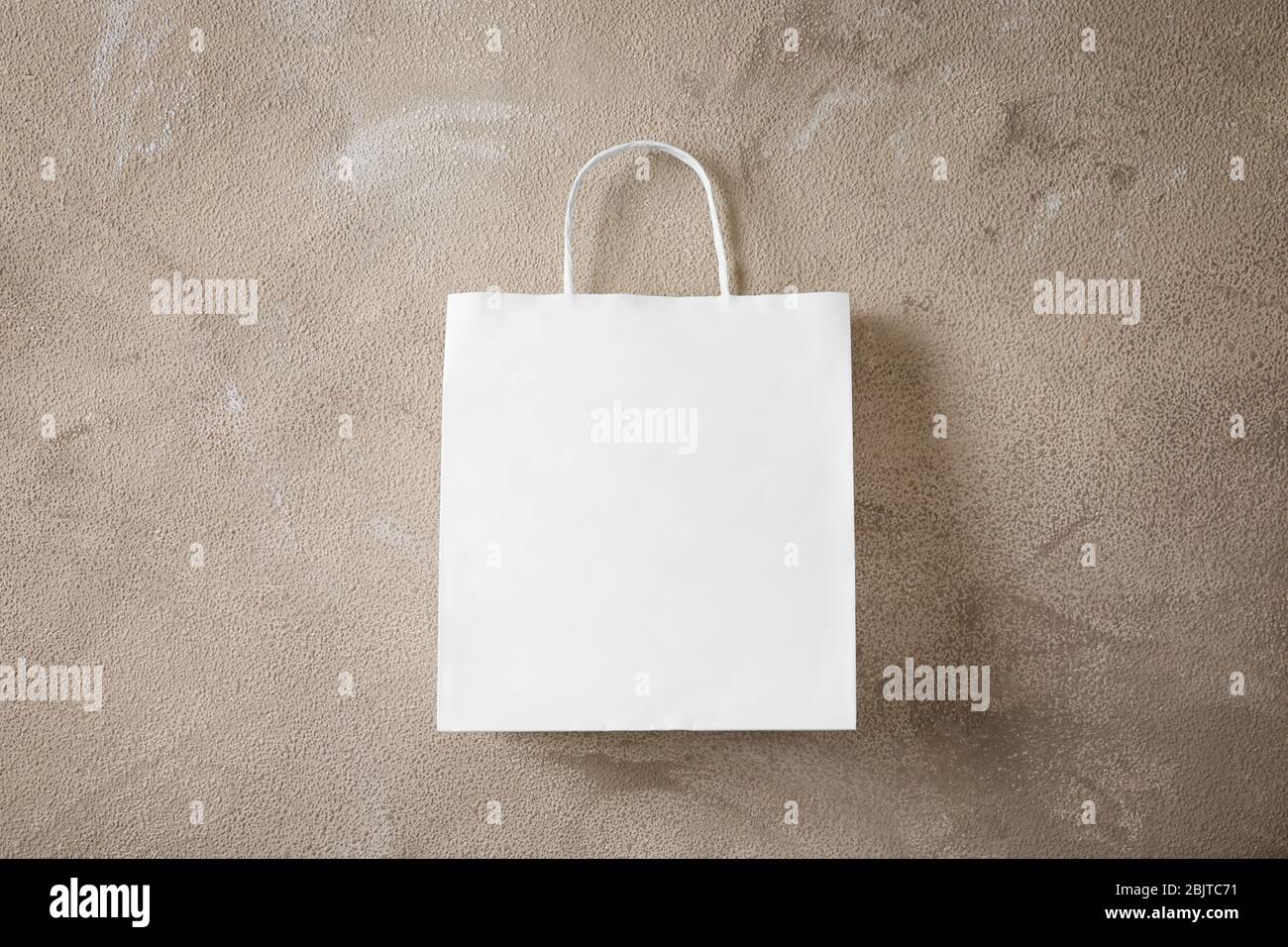 Paper bag on textured background. Mockup for design Stock Photo - Alamy