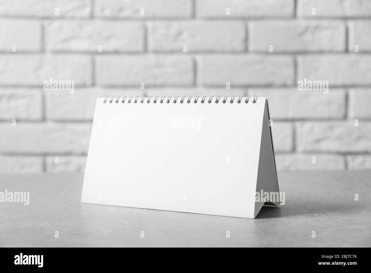 Blank desk calendar on table. Mockup for design Stock Photo - Alamy