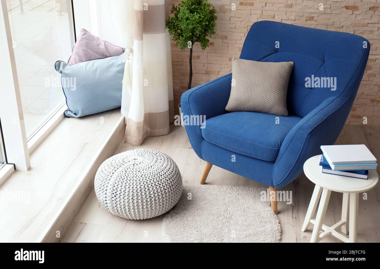 Interior of living room with comfortable armchair Stock Photo - Alamy