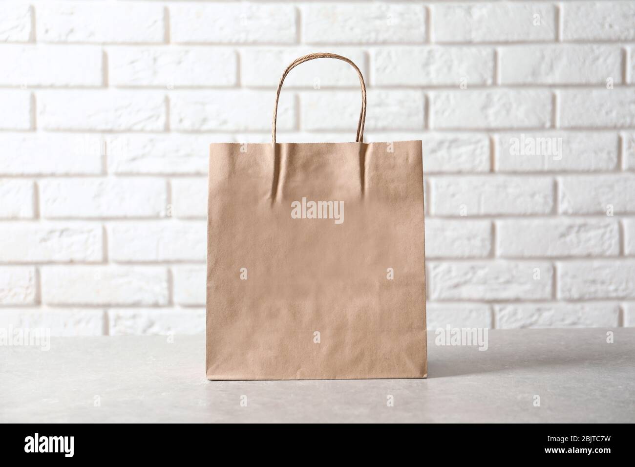Paper bag on table. Mockup for design Stock Photo - Alamy