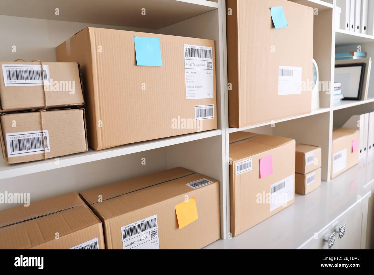 Shelving with parcels ready for shipment to customers in home office ...