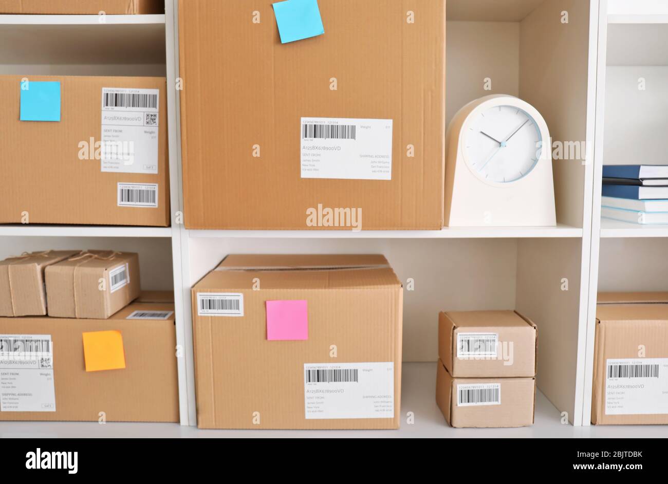 Shelving with parcels ready for shipment to customers in home office ...