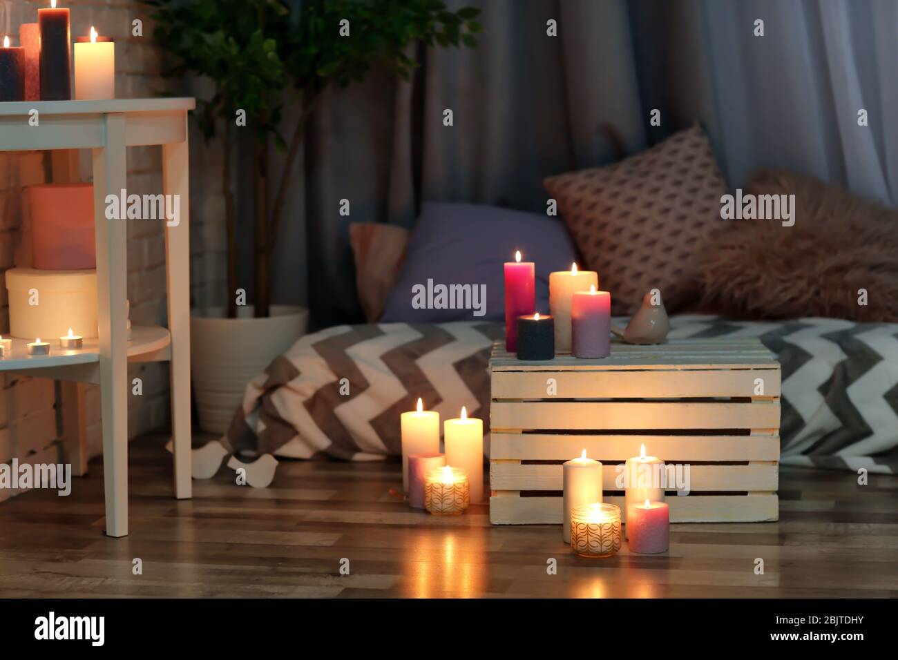 Cozy room decorated with burning candles Stock Photo - Alamy