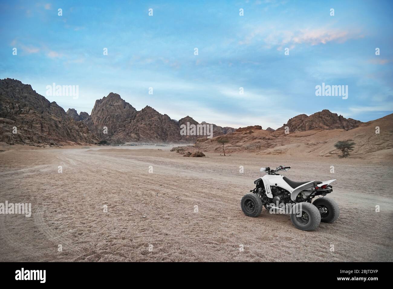 Modern quad bike in desert Stock Photo - Alamy