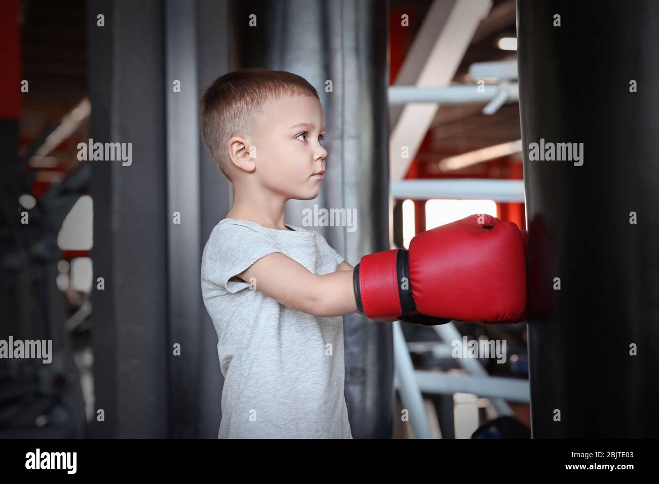 Little boy training with punchbag in boxing gym Stock Photo - Alamy