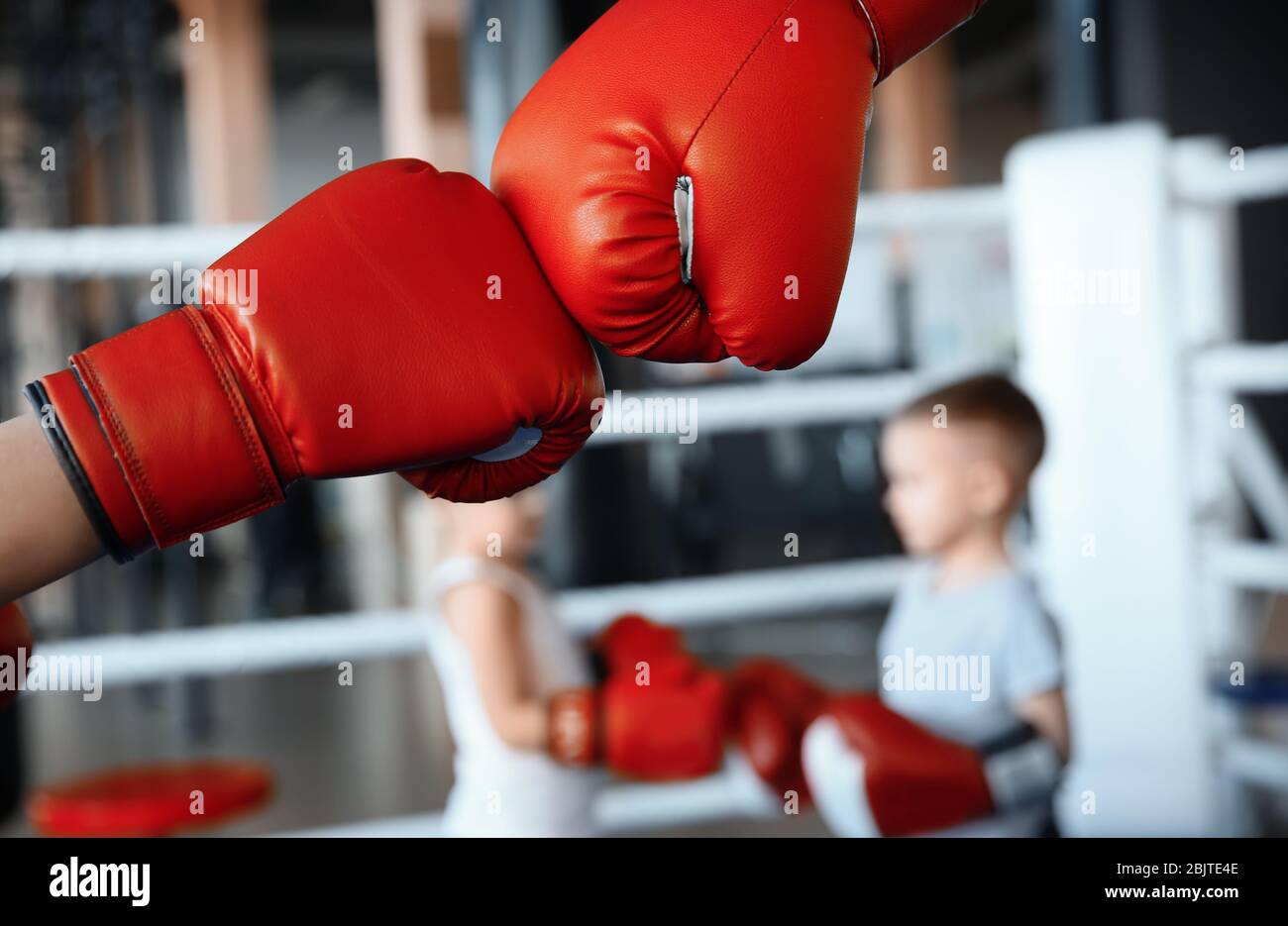 Little kid with trainer in boxing gloves on ring Stock Photo - Alamy