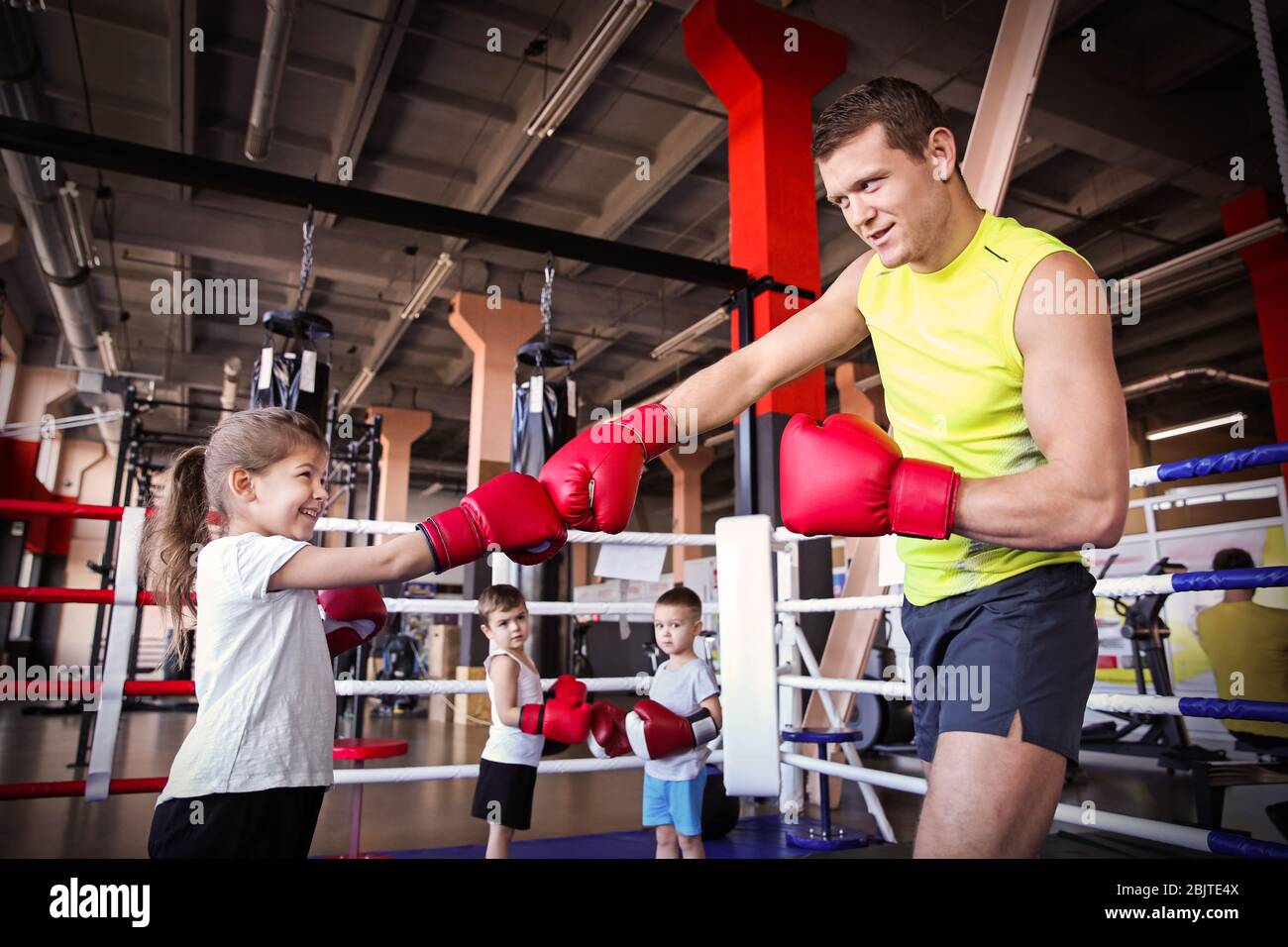 Little girl training with coach in boxing ring Stock Photo - Alamy