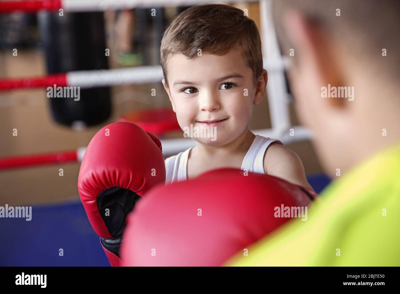 Little boy training with coach in boxing ring Stock Photo - Alamy