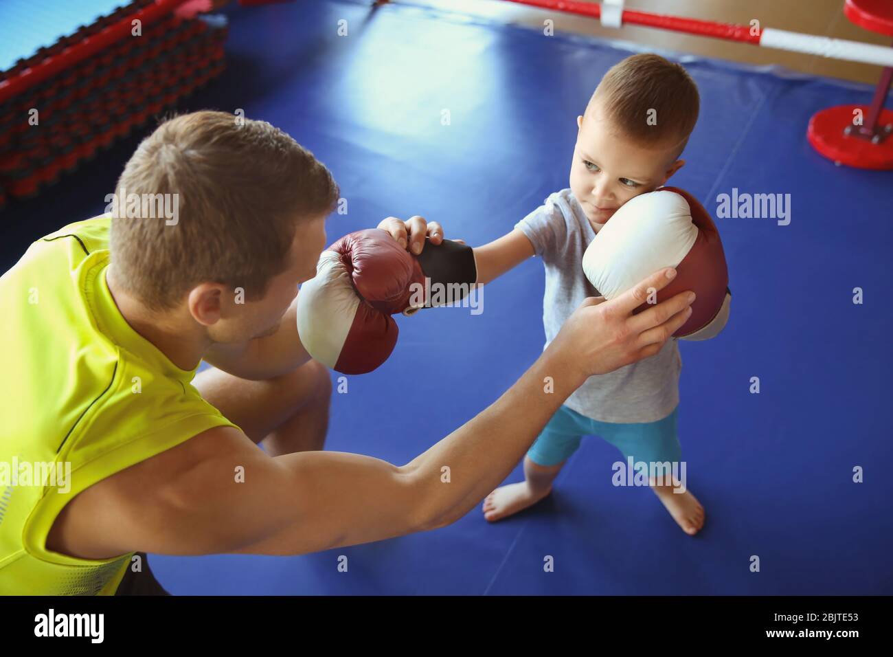 Little boy training with coach in boxing ring Stock Photo - Alamy