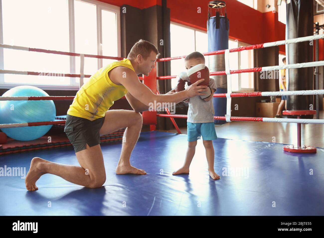 Little boy training with coach in boxing ring Stock Photo - Alamy