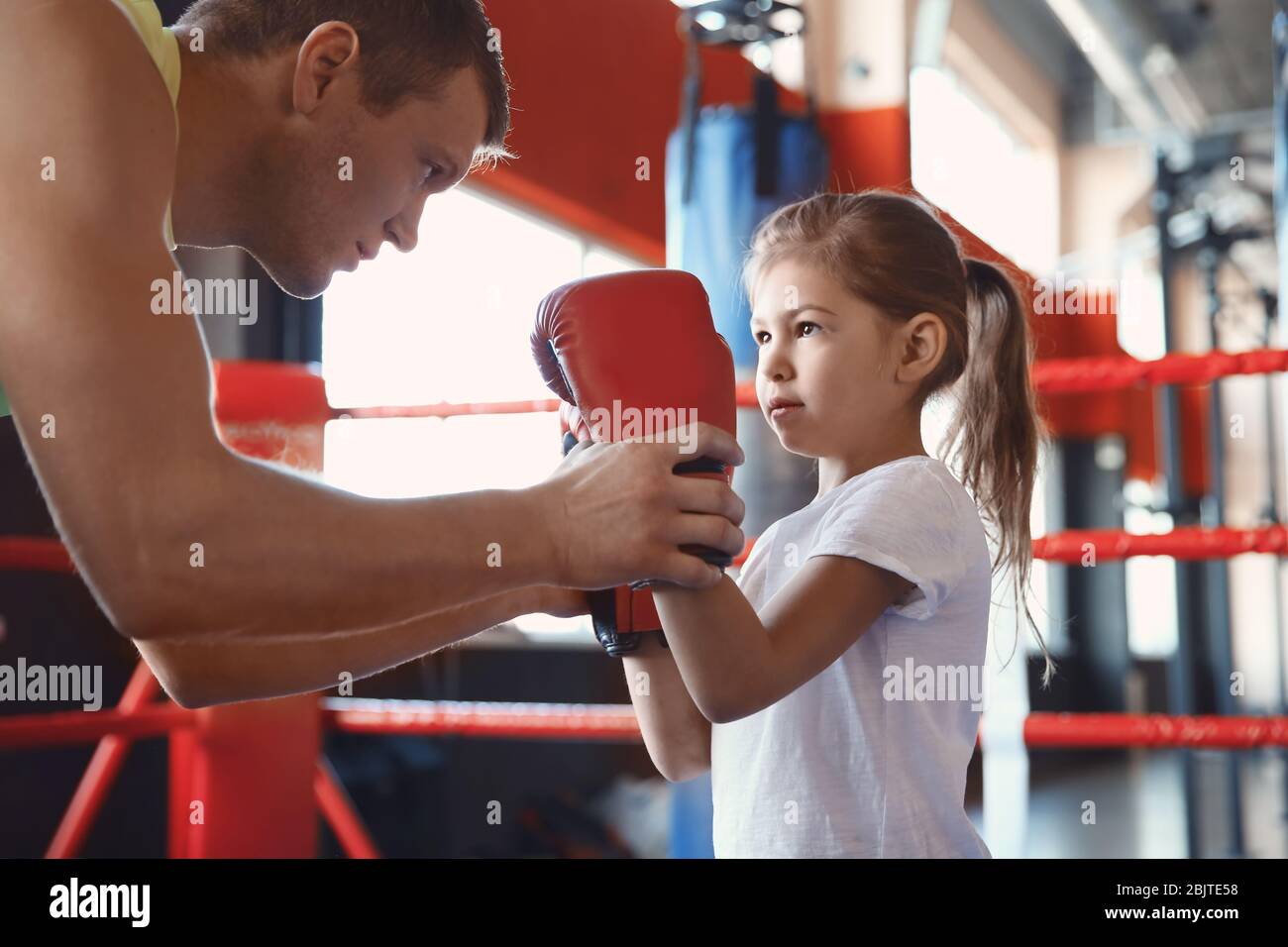 Little girl training with coach in boxing ring Stock Photo - Alamy