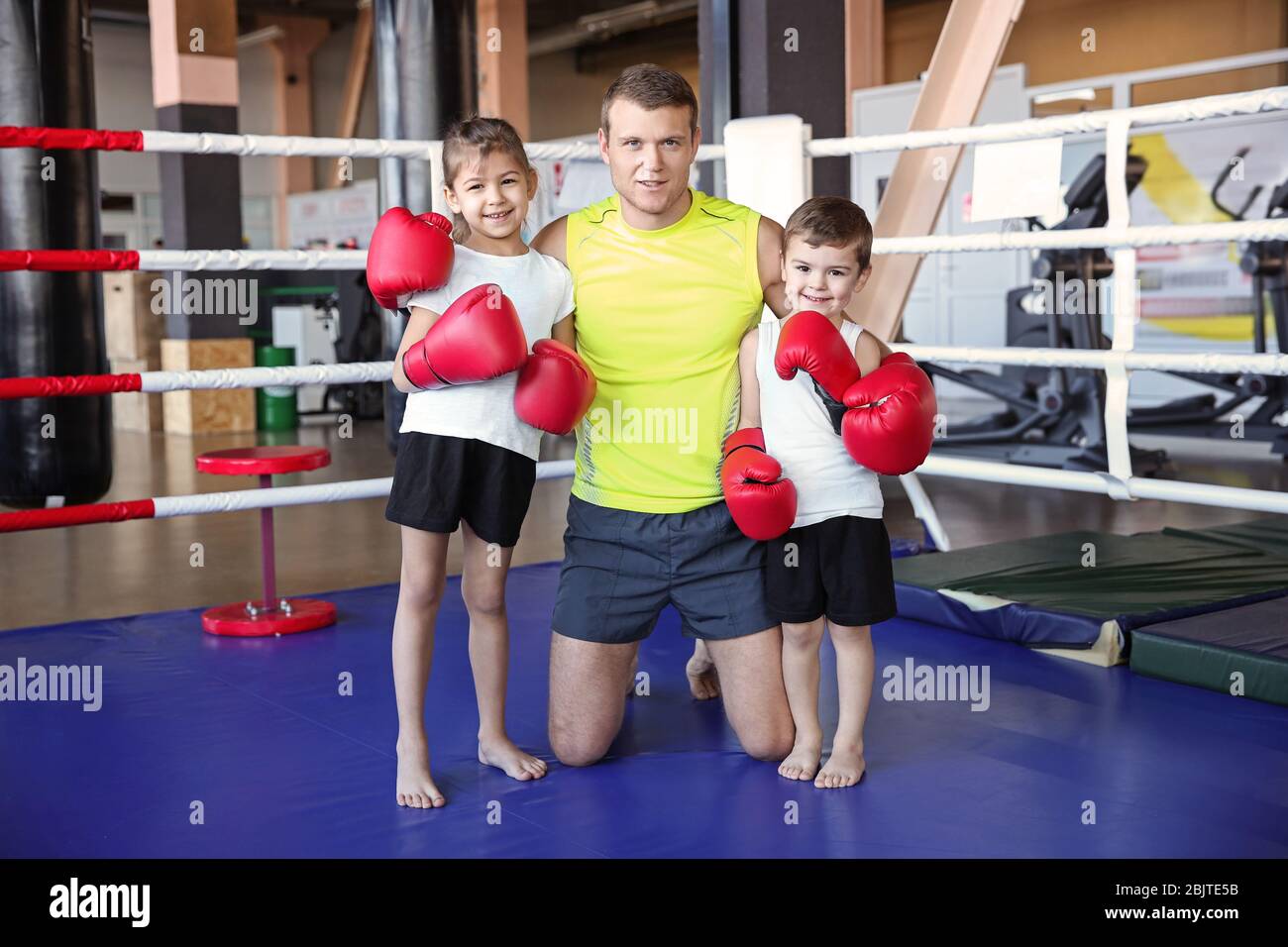Little children with trainer in boxing ring Stock Photo - Alamy