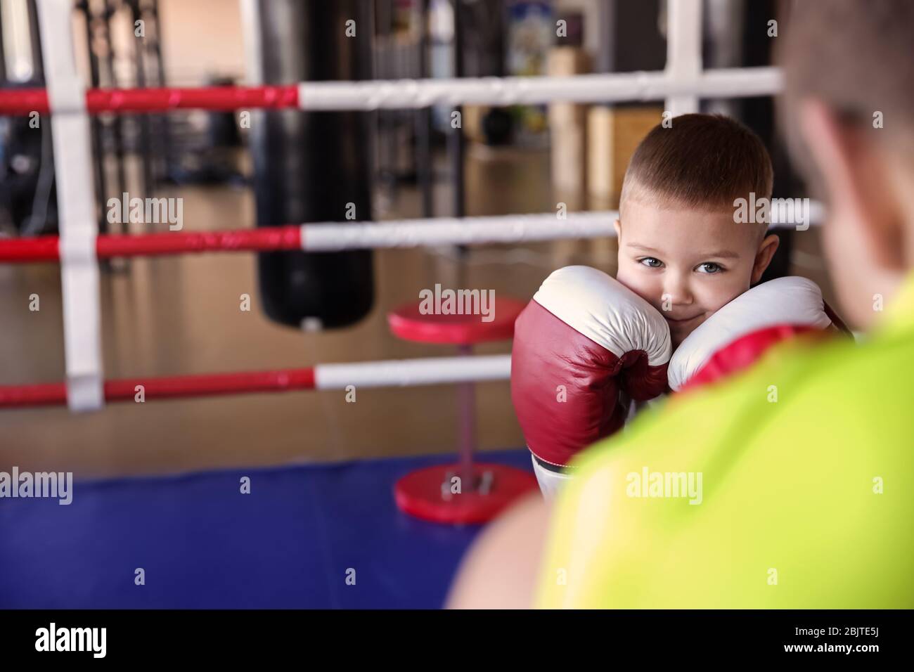 Little boy training with coach in boxing ring Stock Photo - Alamy