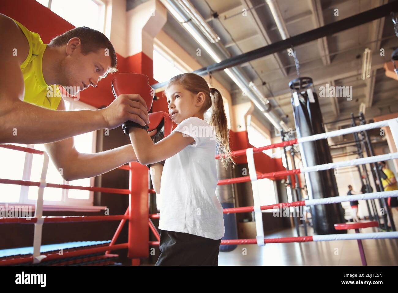 Little girl training with coach in boxing ring Stock Photo - Alamy