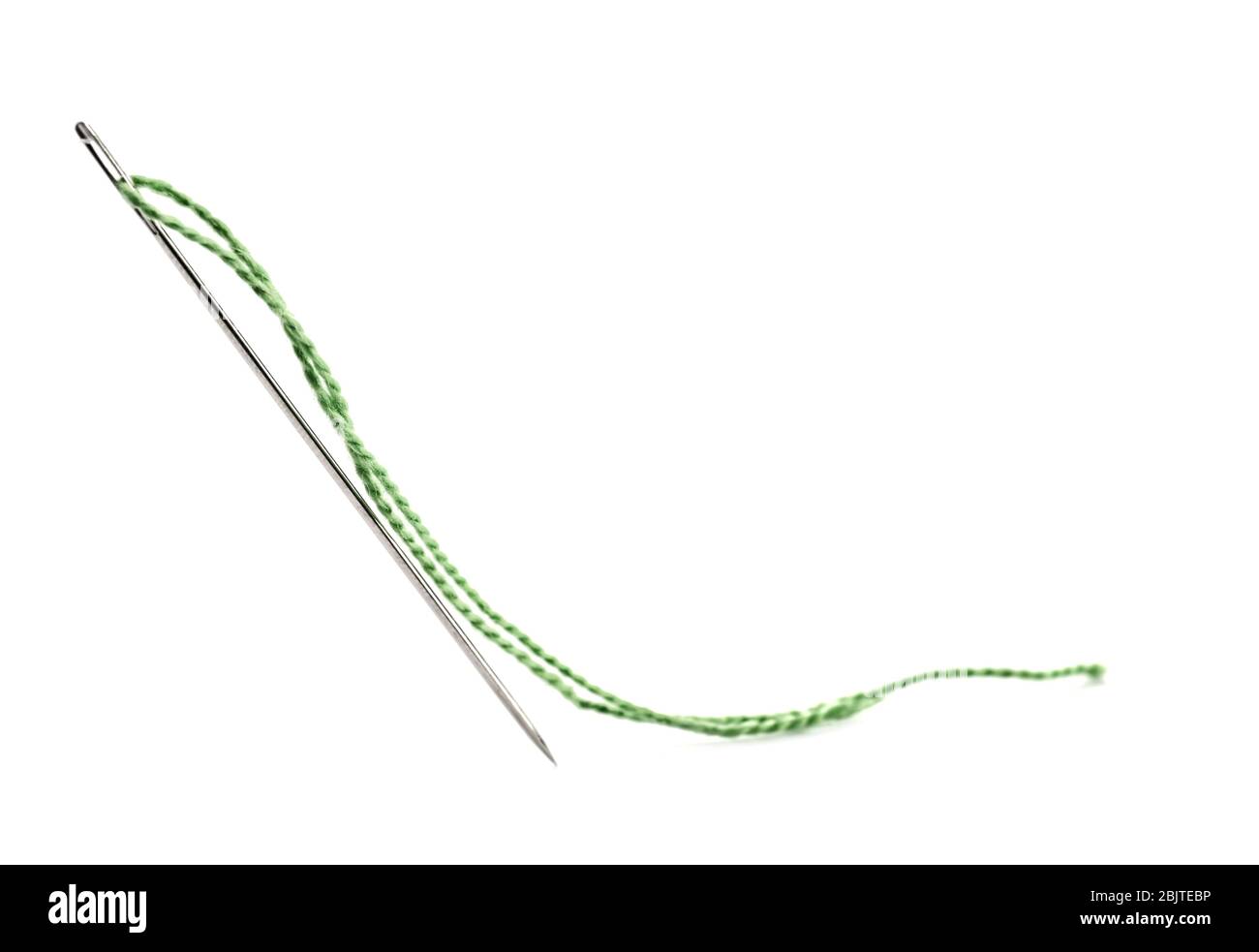 Sewing needle with thread on white background Stock Photo - Alamy