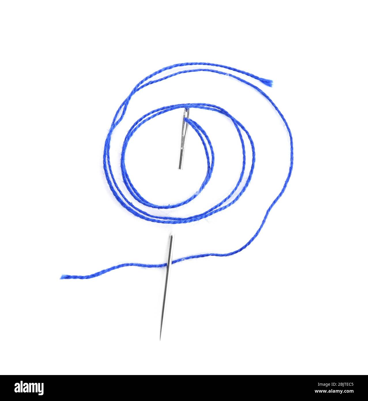 Needle with sewing thread on white background Stock Photo - Alamy