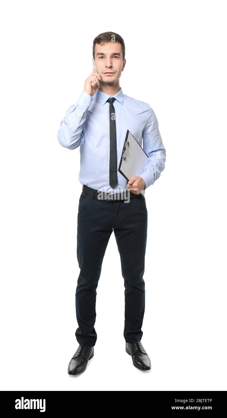 Handsome car salesman talking on mobile phone against white background ...
