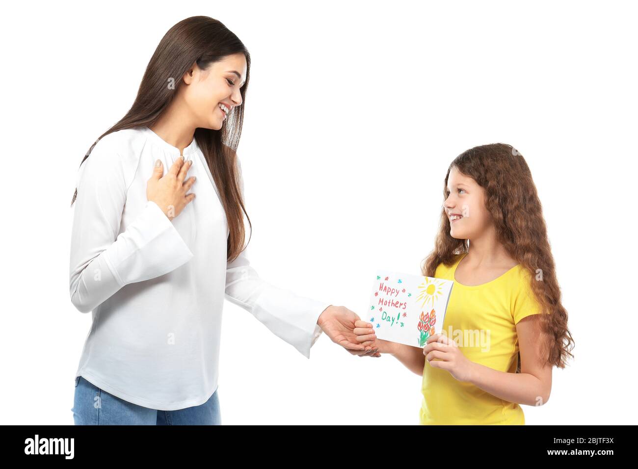 Cute little girl giving greeting card to her mom on white background ...