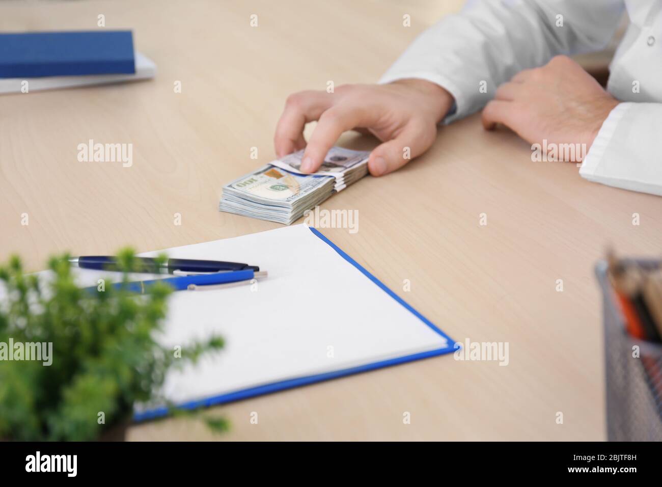 Male doctor taking bribe hi-res stock photography and images - Alamy