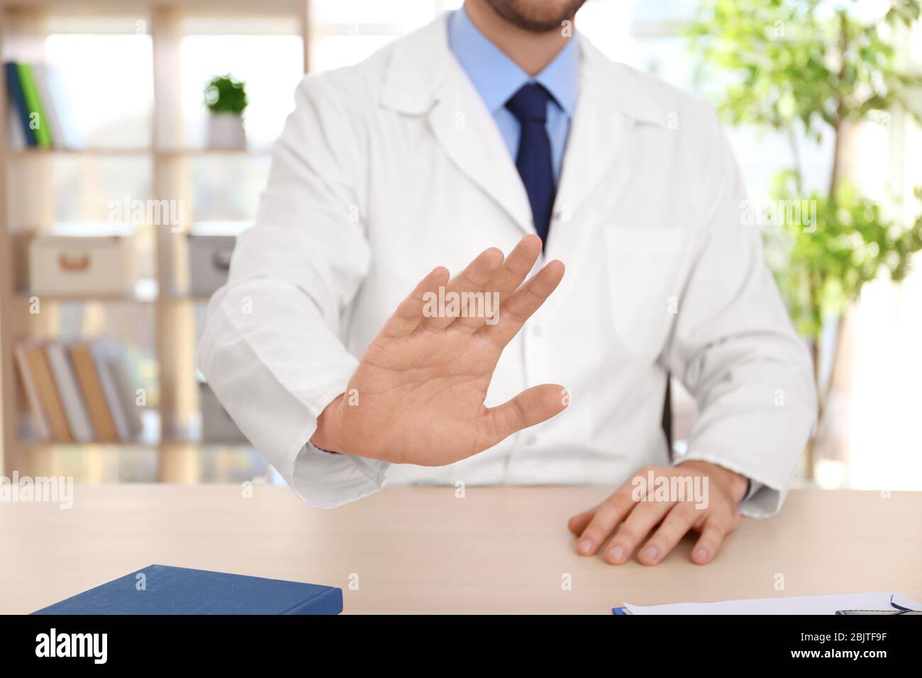 Male doctor refusing to take bribe at workplace Stock Photo - Alamy
