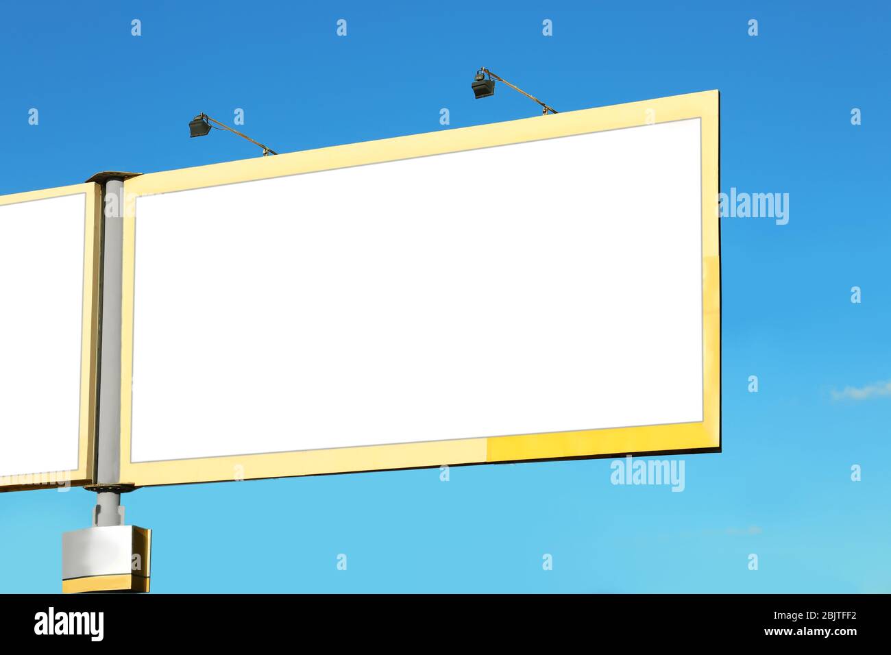 Blank advertising board on blue sky background Stock Photo - Alamy