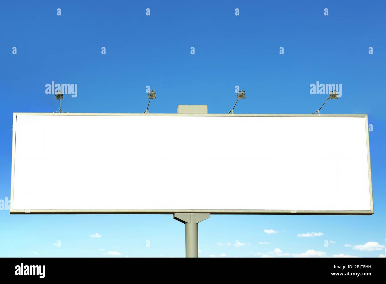 Blank advertising board on blue sky background Stock Photo - Alamy