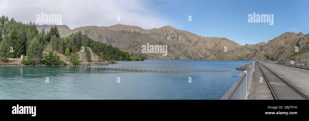 landscape with Benmore lake dam top road and barren lake shores , shot ...