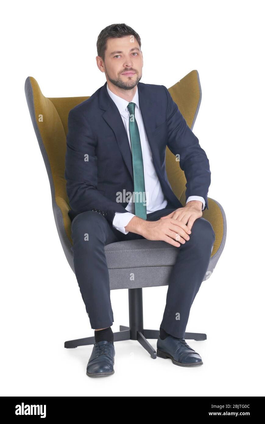 Handsome businessman sitting in comfortable armchair on white ...