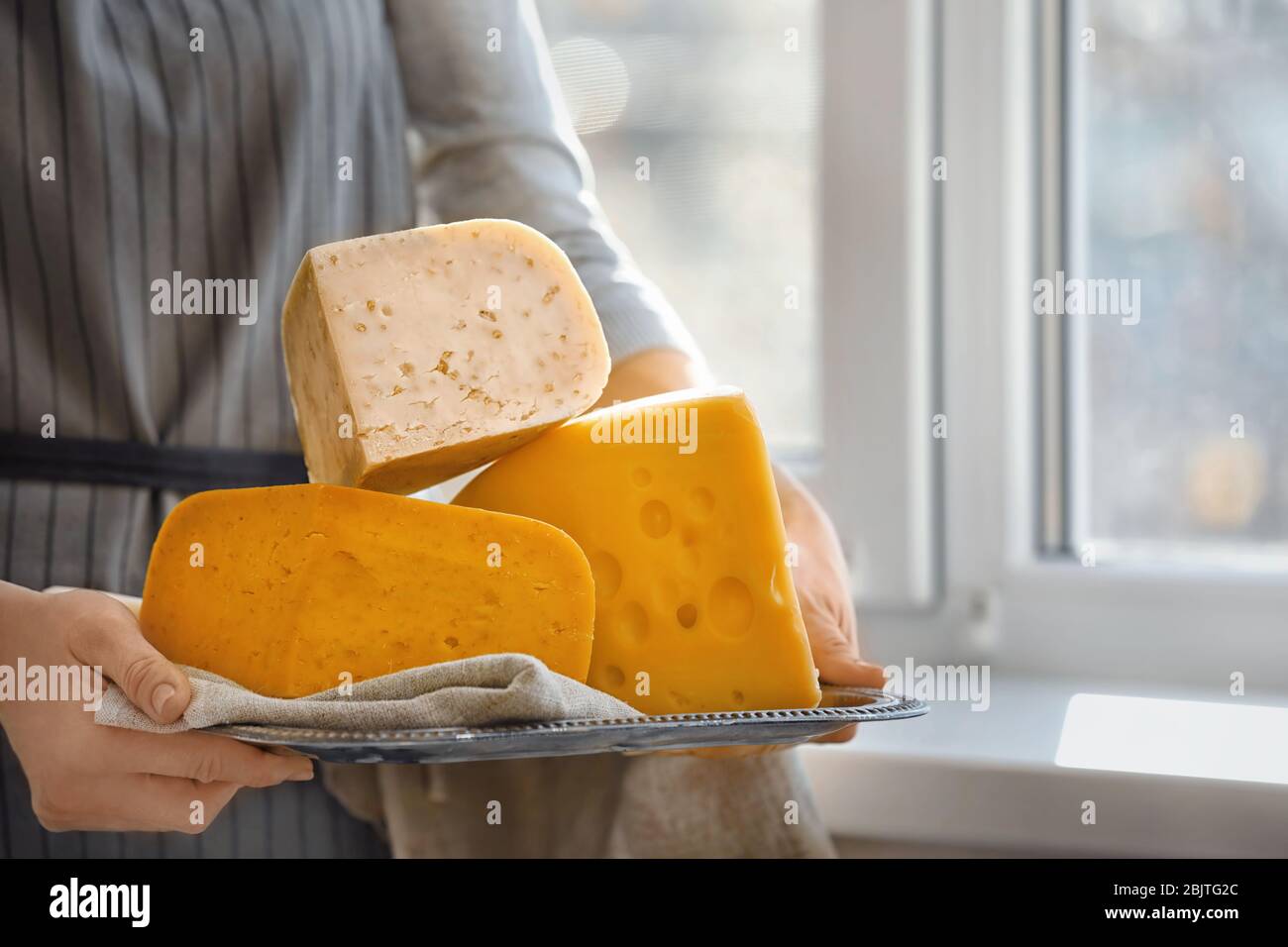Woman holding cheese tray hi-res stock photography and images - Alamy