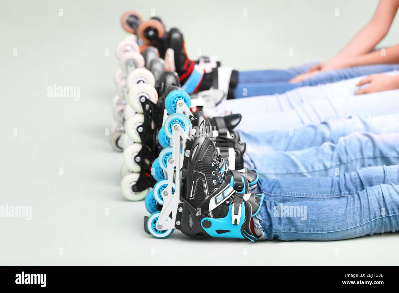 Group of people wearing roller skates on light background Stock Photo ...